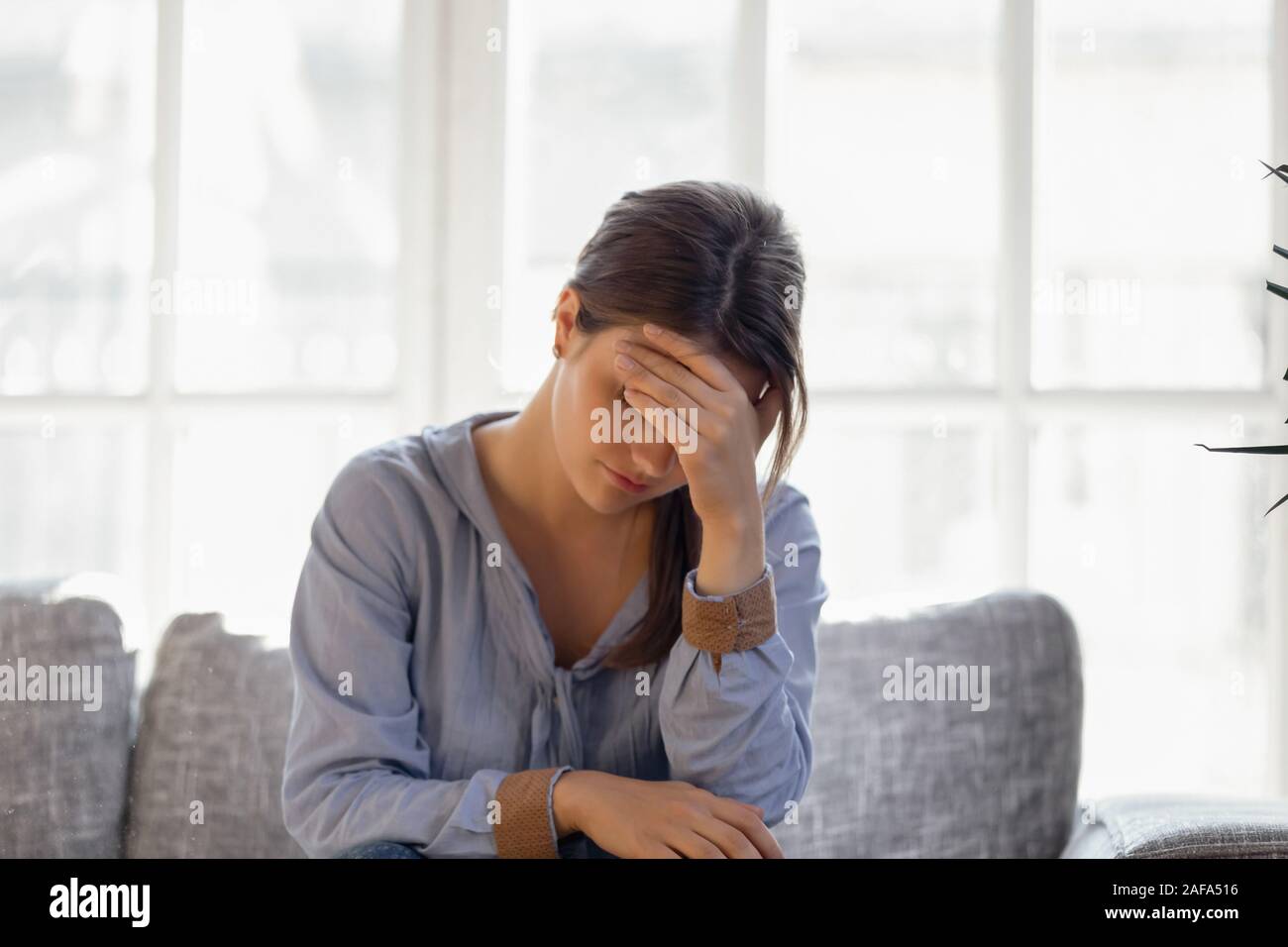 Upset young woman hiding face, crying, thinking about problem Stock ...