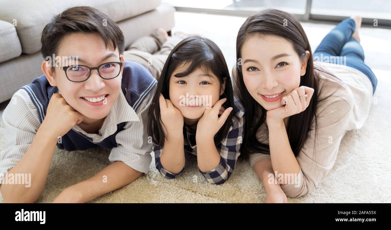 happy asian family spending time together on sofa in living room ...