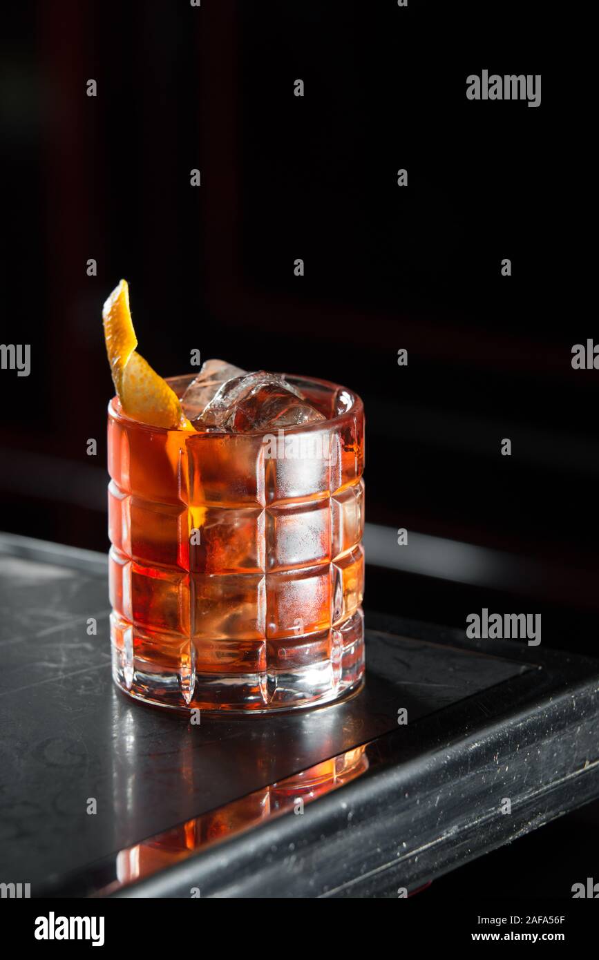 Boulevardie cocktail on a bar desk. black background Stock Photo - Alamy