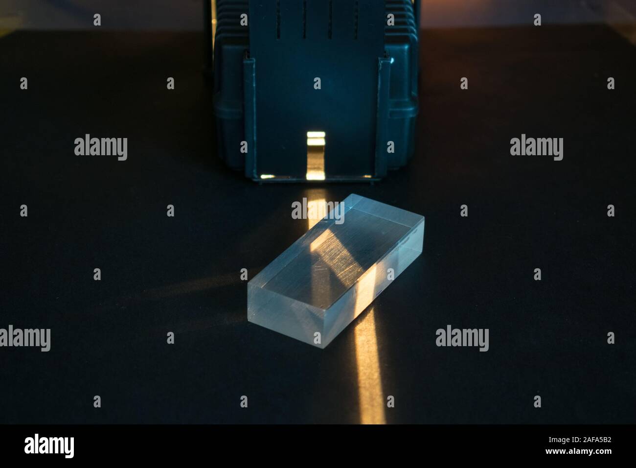 Demonstration of breaking of light in piece of glass in physics ...