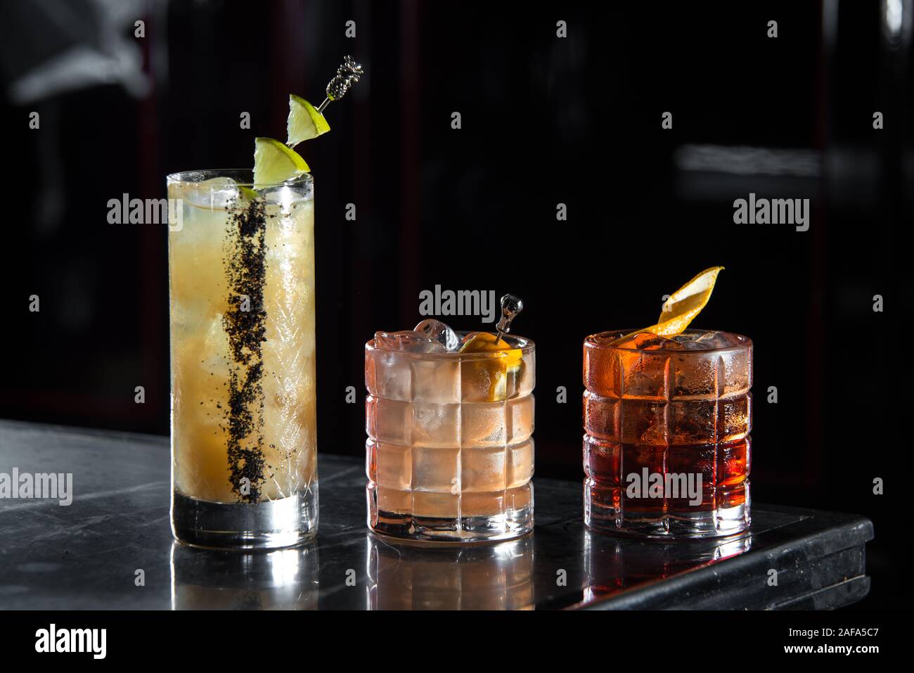 three special cocktails cocktail on a bar desk. black background Stock ...