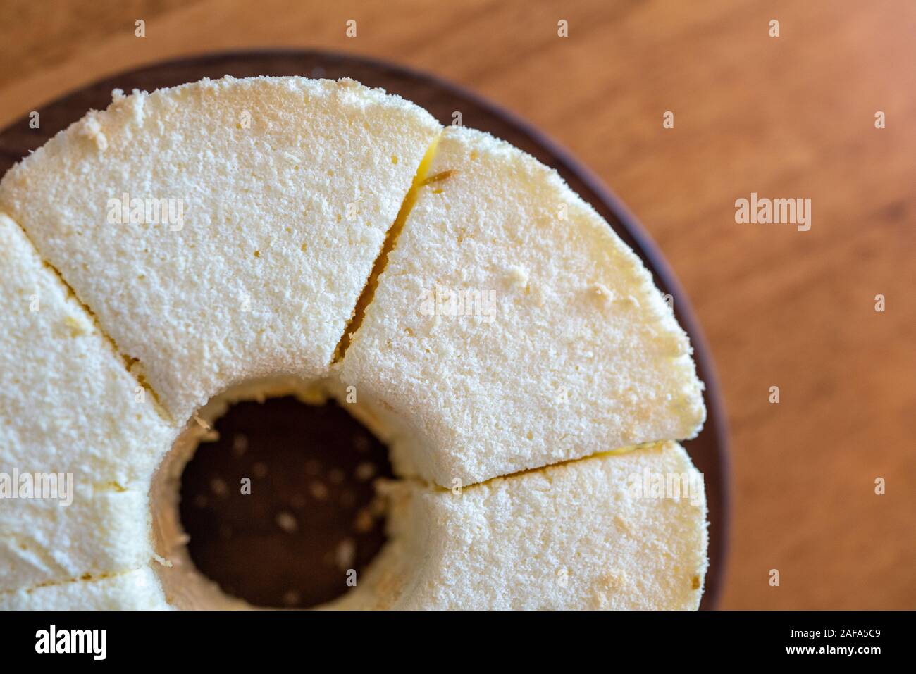 Homemade tasty chiffon cake on a wooden plate. Top view from above ...