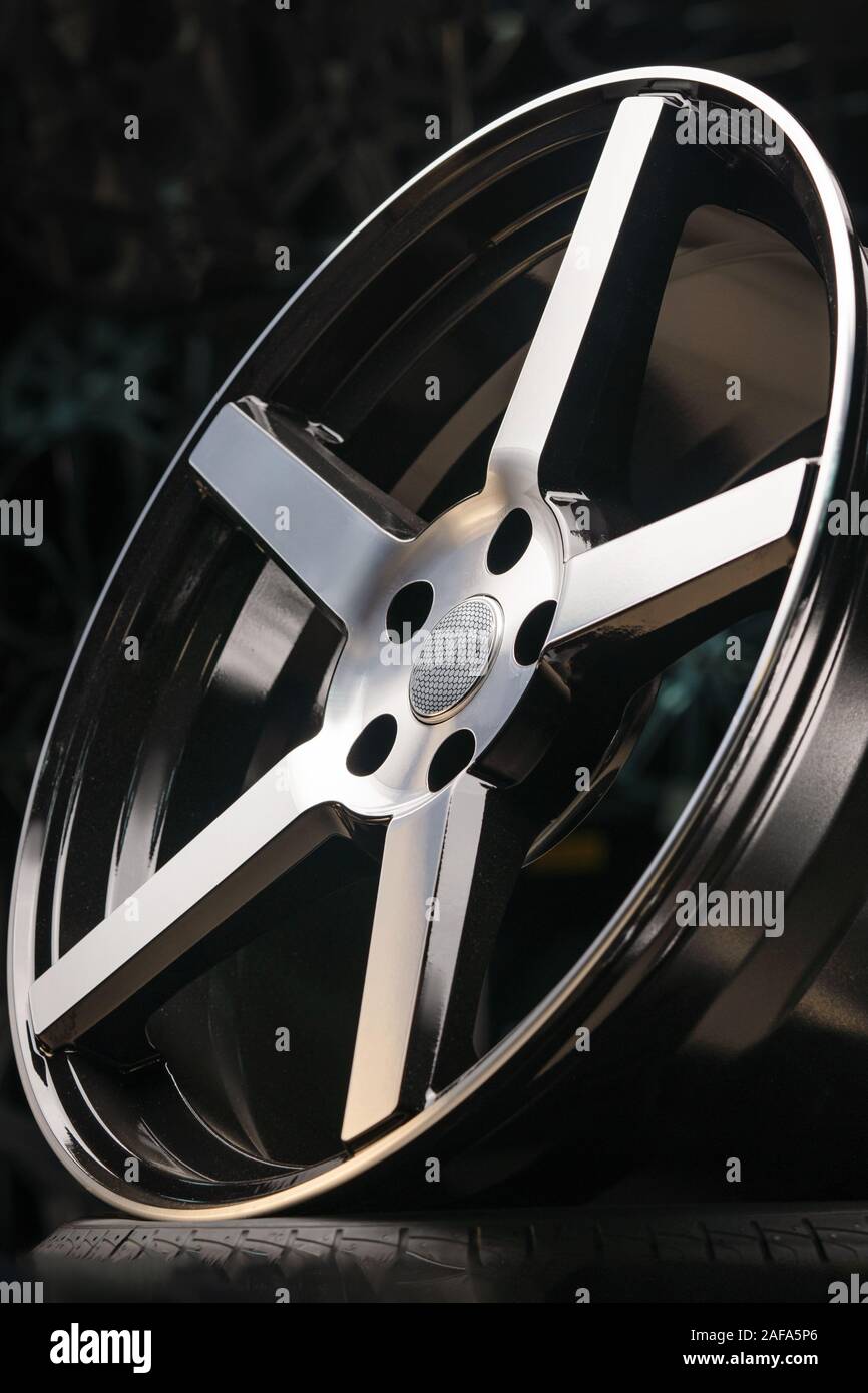 cast aluminum disc alloy wheel modern, close-up on black background ...