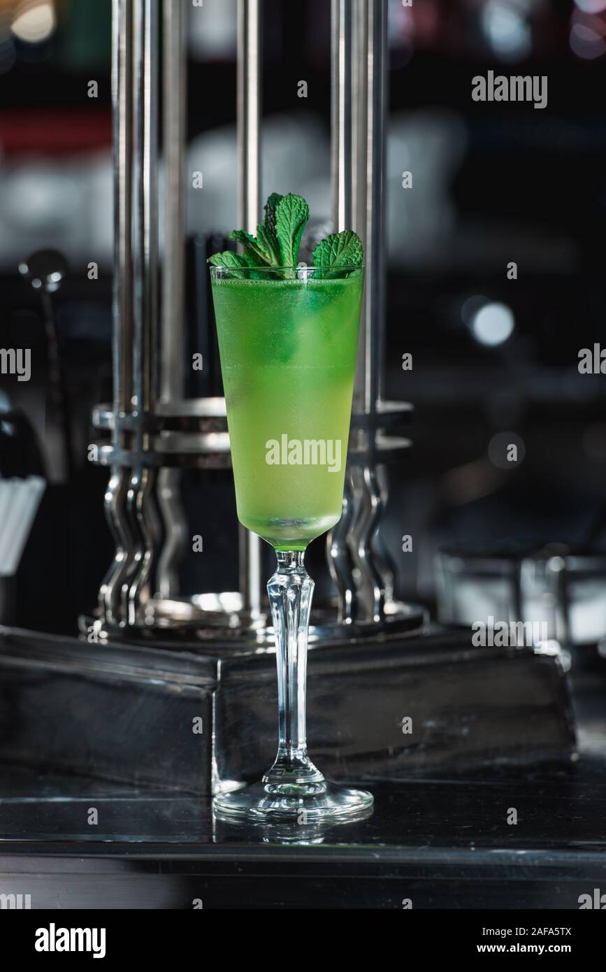 Green Alcoholic Cocktail on bar desk. Mint on top Stock Photo - Alamy