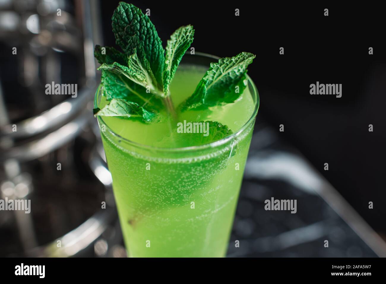 Green Alcoholic Cocktail on bar desk. Mint on top Stock Photo - Alamy