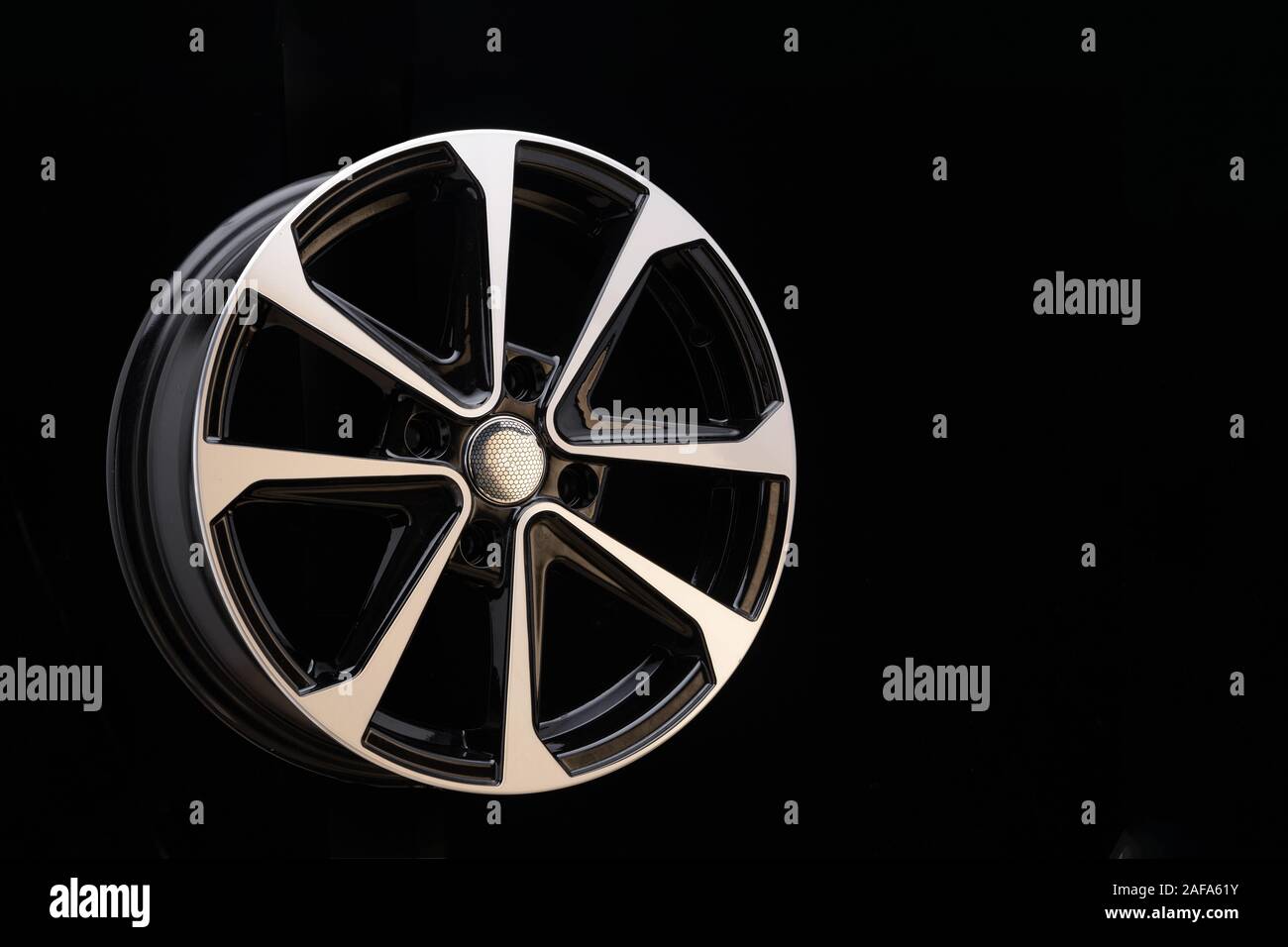 cast aluminum disc alloy wheel modern, close-up on black background ...