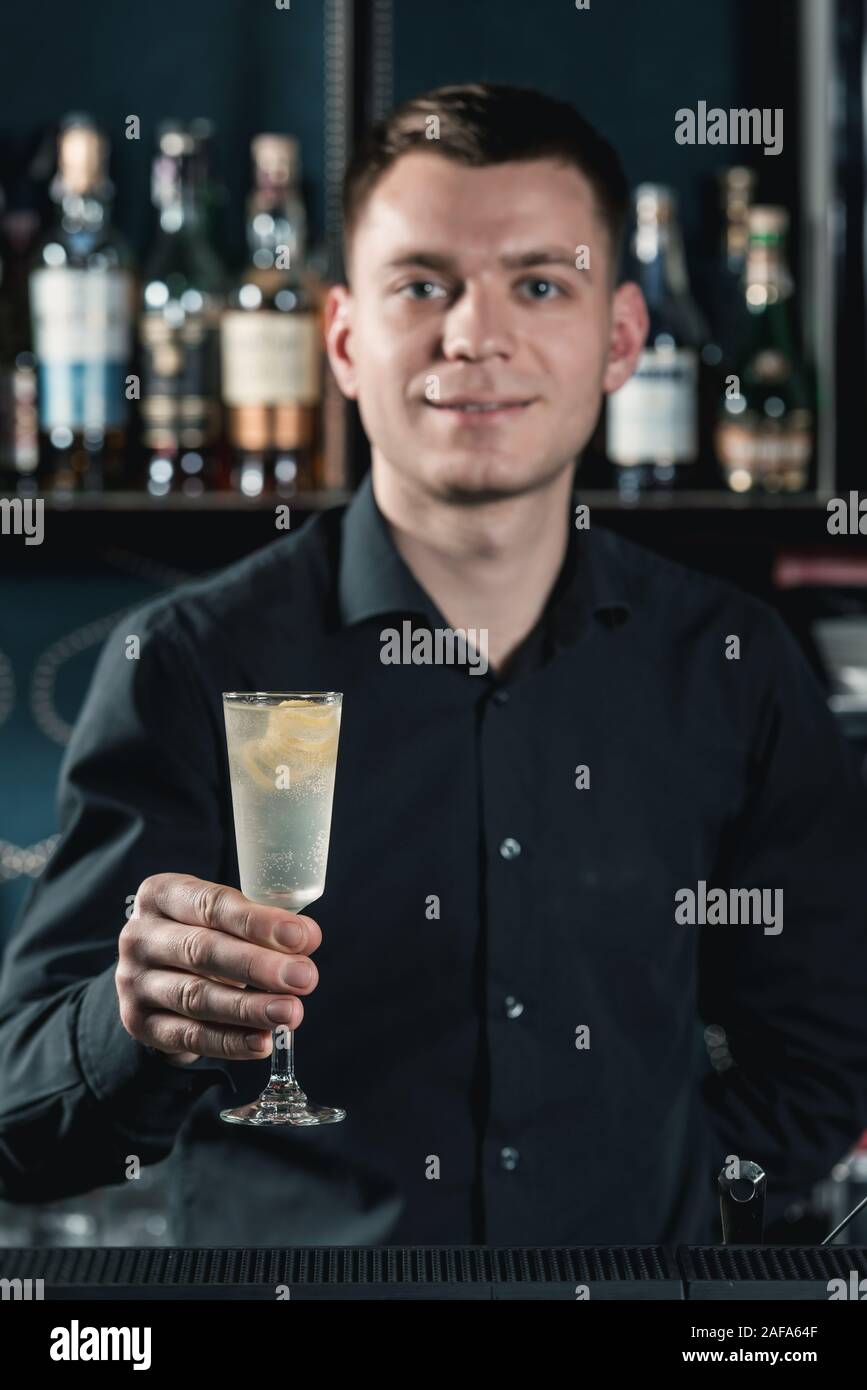 bartender offering French 75 Cocktail. Bar on a background Stock Photo ...