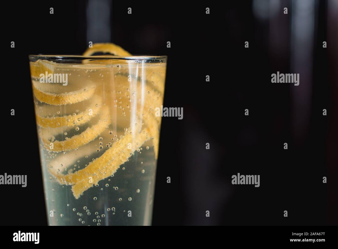 French 75 Alcoholic Cocktail garnish with a long ribbon of lemon peel ...