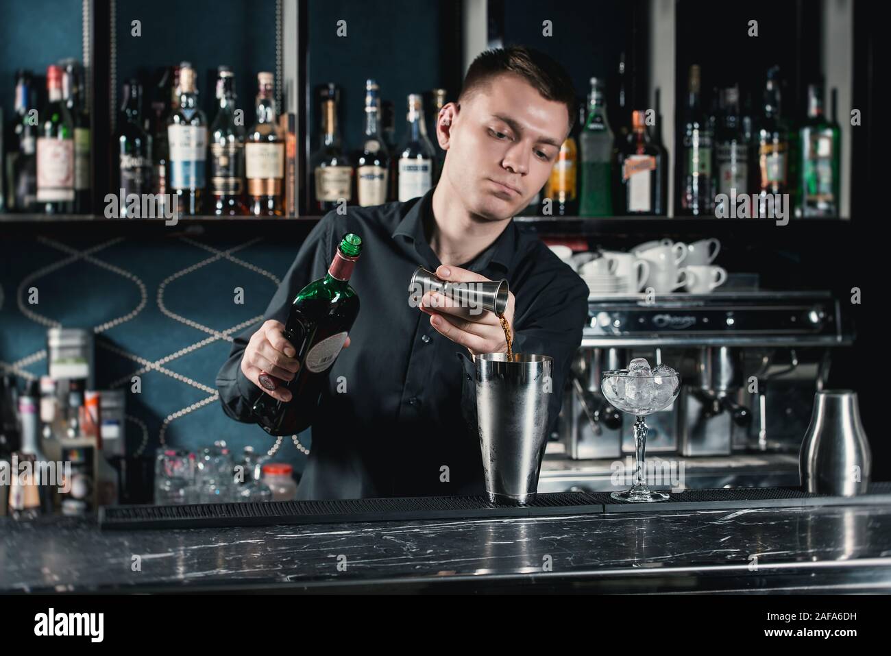 bartender making Boulevardier Cocktail pouring fluid into glass. Bar on a background Stock Photo ...