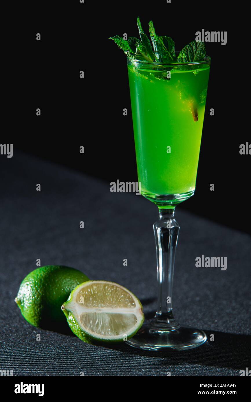 Green Alcoholic Cocktail on a black background. Mint on top Stock Photo ...