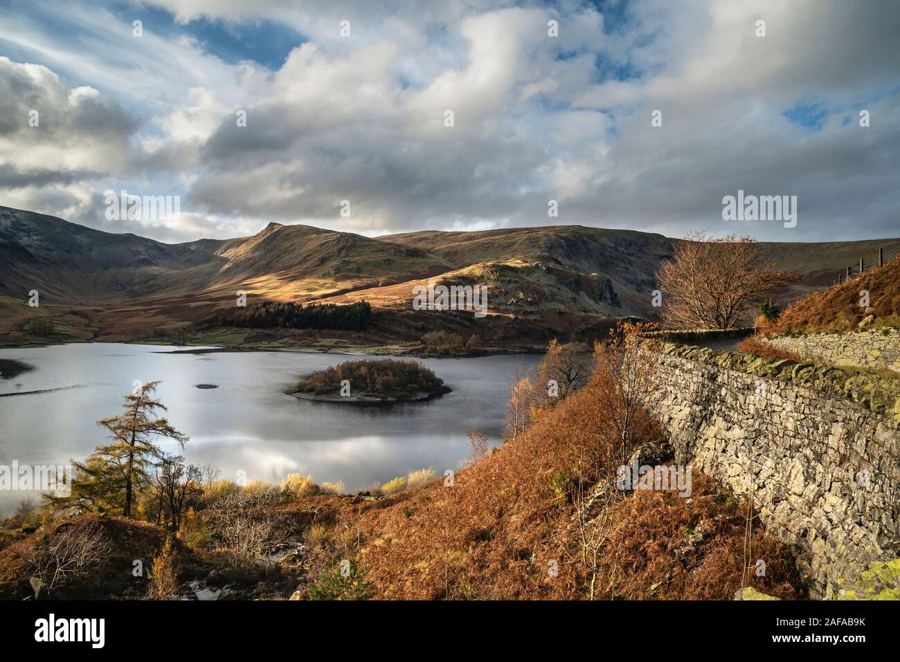 Epic Autumn Fall landscape of Hawes Water with epic lighting and ...