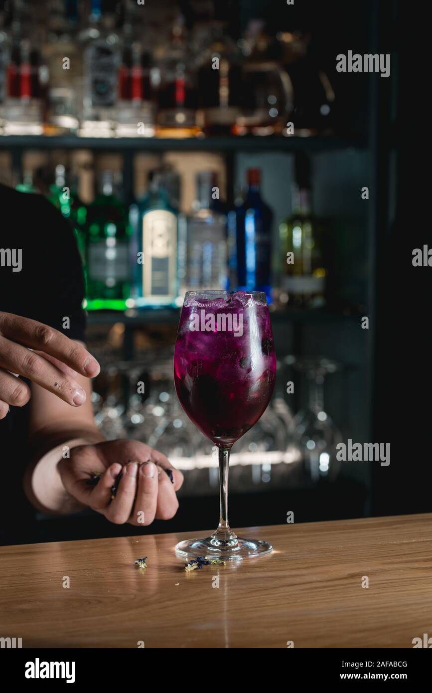 Wine glass with magenta cocktail drink, against bar background Stock ...