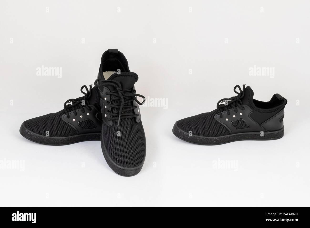 black leather sneakers shoes isolated on white background side and ...