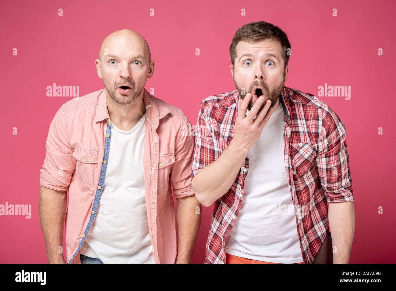 Portrait of two shocked young people who, from an unexpected surprise ...