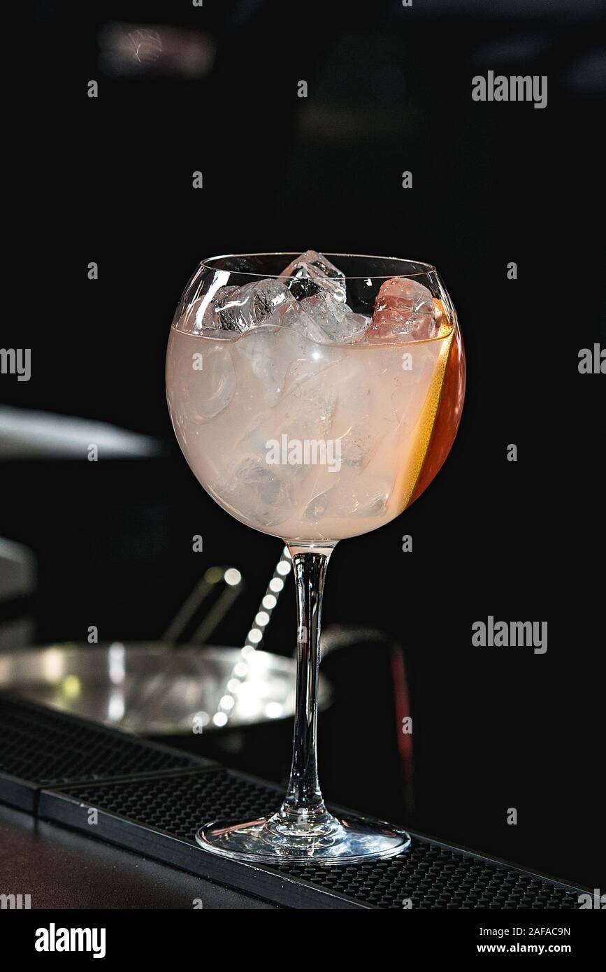 refreshing ruby red coctail with grape fruit isolated on a bar ...