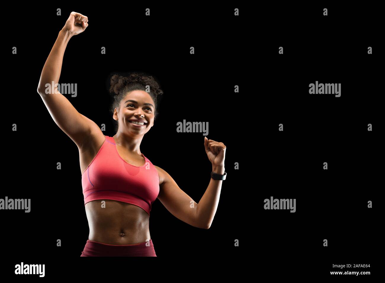 Cheerful fitness model raising her hands up, celebrating success Stock ...