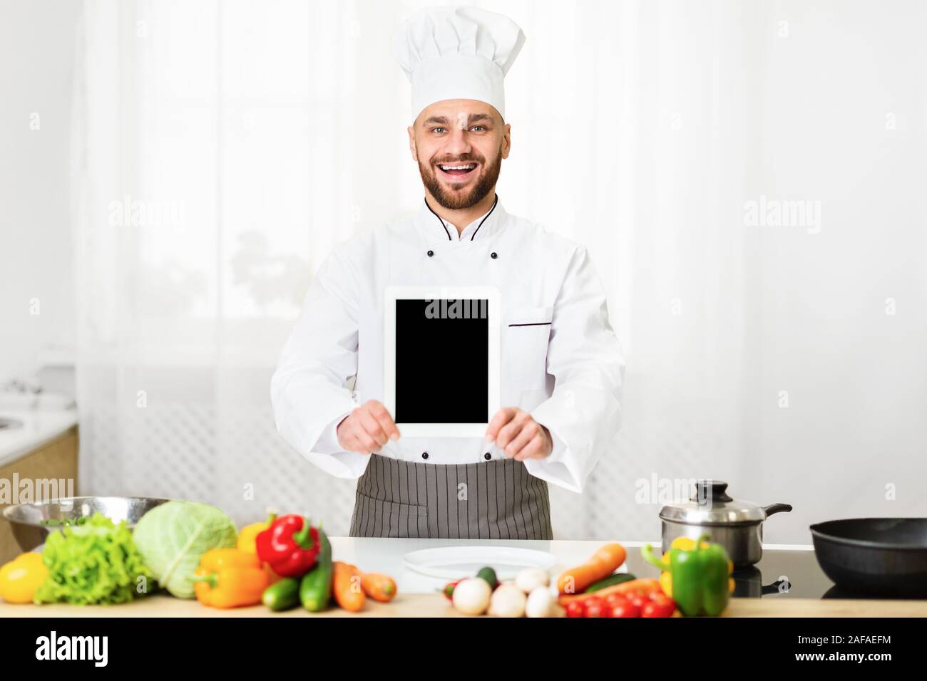 Man in white uniform holding tablet hi-res stock photography and images ...