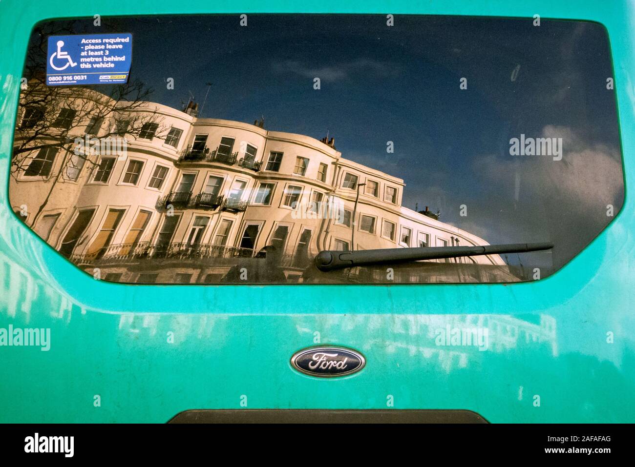 Classic Regency architecture reflected in the rear window of a taxi in ...