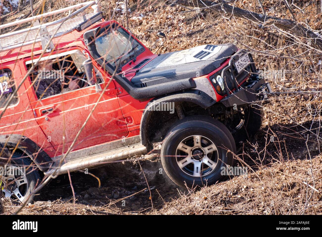 Jeep Suzuki Jimny overcomes obstacles in the forest Stock Photo - Alamy