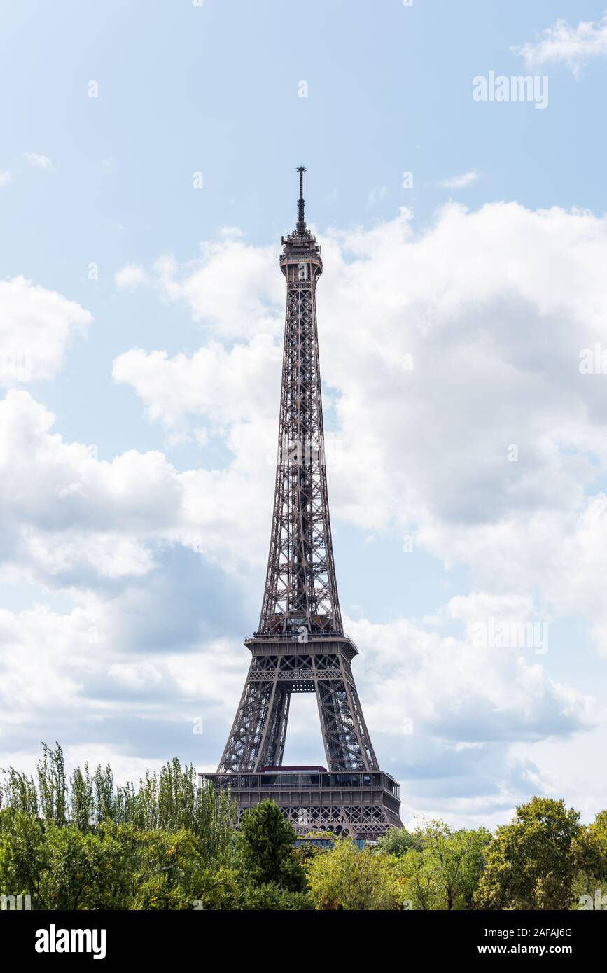 The Eiffel Tower against blue and cloudy sky, a wrought-iron lattice ...