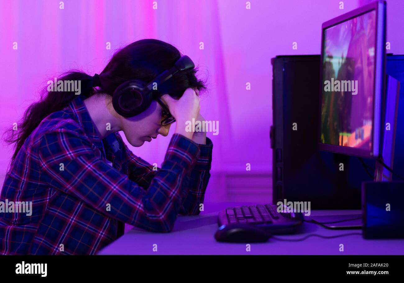 Upset young woman losing computer game at home Stock Photo - Alamy