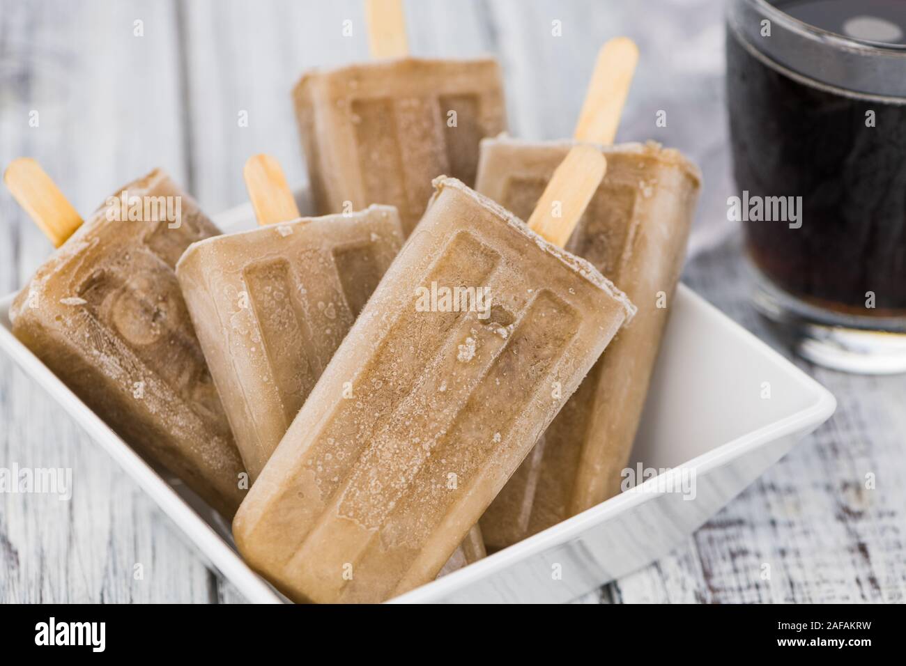 Some homemade Cola Popsicles (close-up shot; selective focus) on ...
