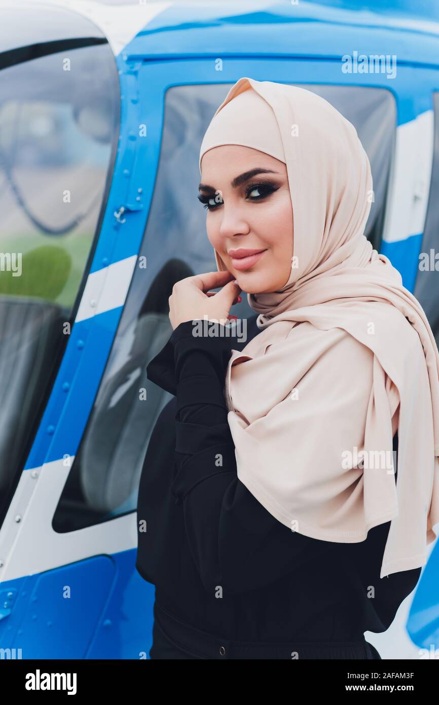 Elegant business muslim arab woman near the helicopter. Business ...
