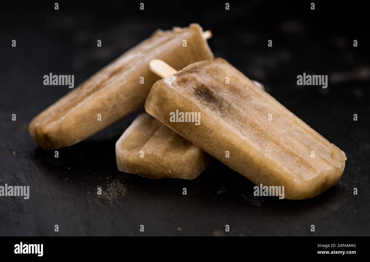 Slate slab with cola popsicles (homemade) as detailed close-up shot ...