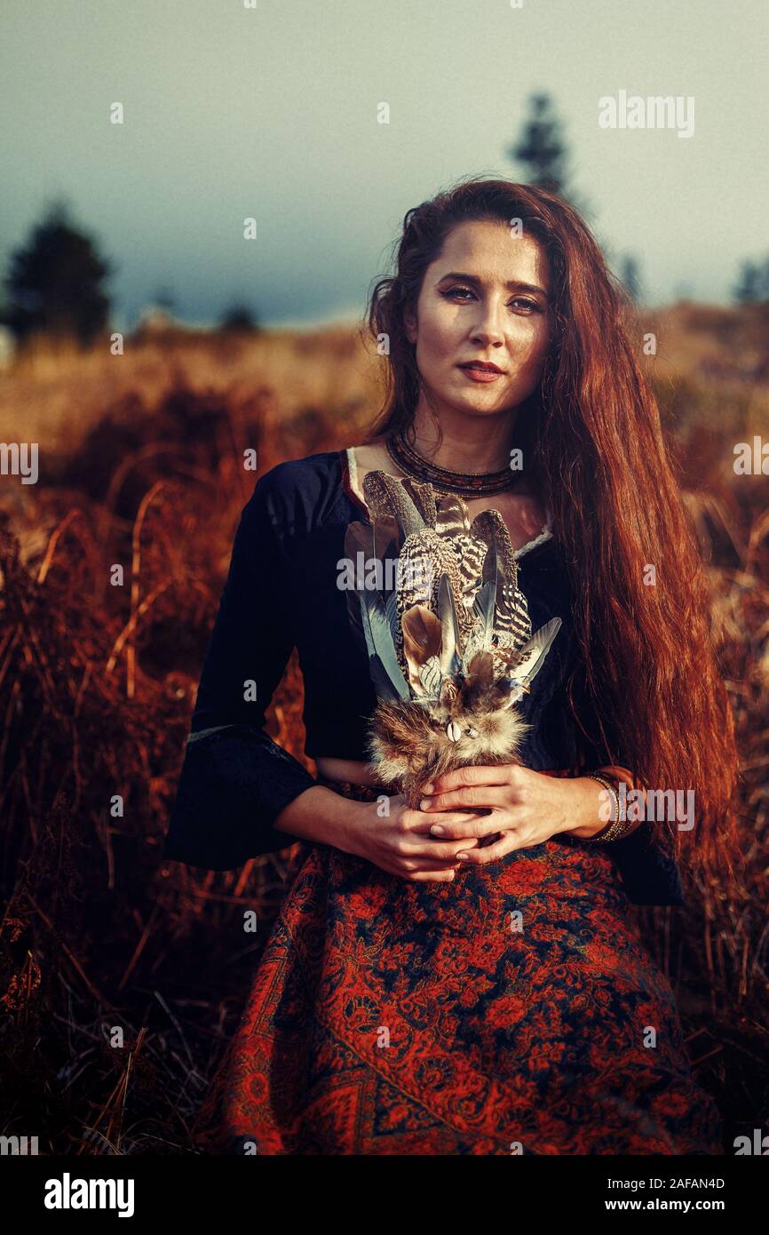 Shaman woman and shamanic feathers on denim Stock Photo - Alamy