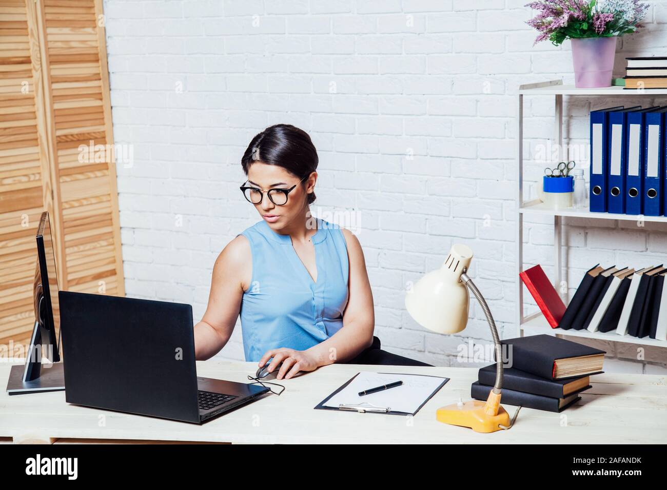 business girl sits at a computer in the Office paper folders Stock ...