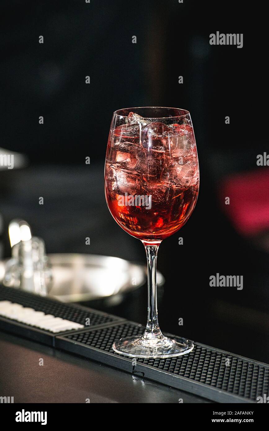 bartender making refreshing pink coctail with a rose on top isolated on ...