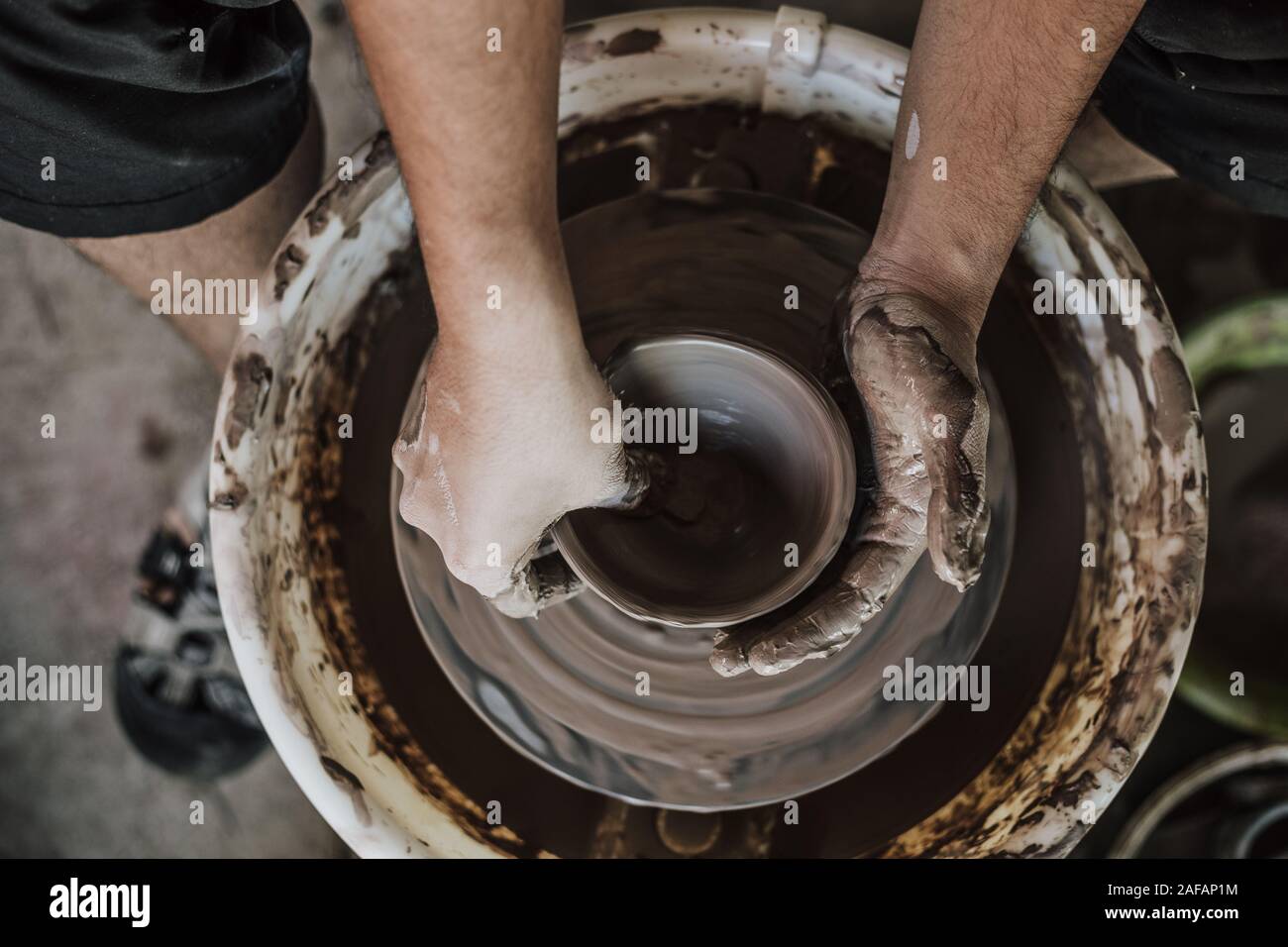 Hands of craftsman artist working on pottery wheel.Selective Focus ...