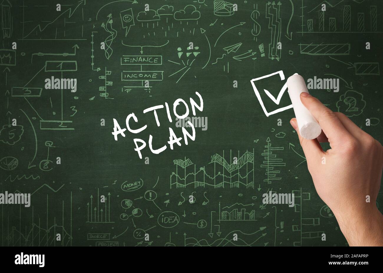 Hand drawing ACTION PLAN inscription with white chalk on blackboard ...