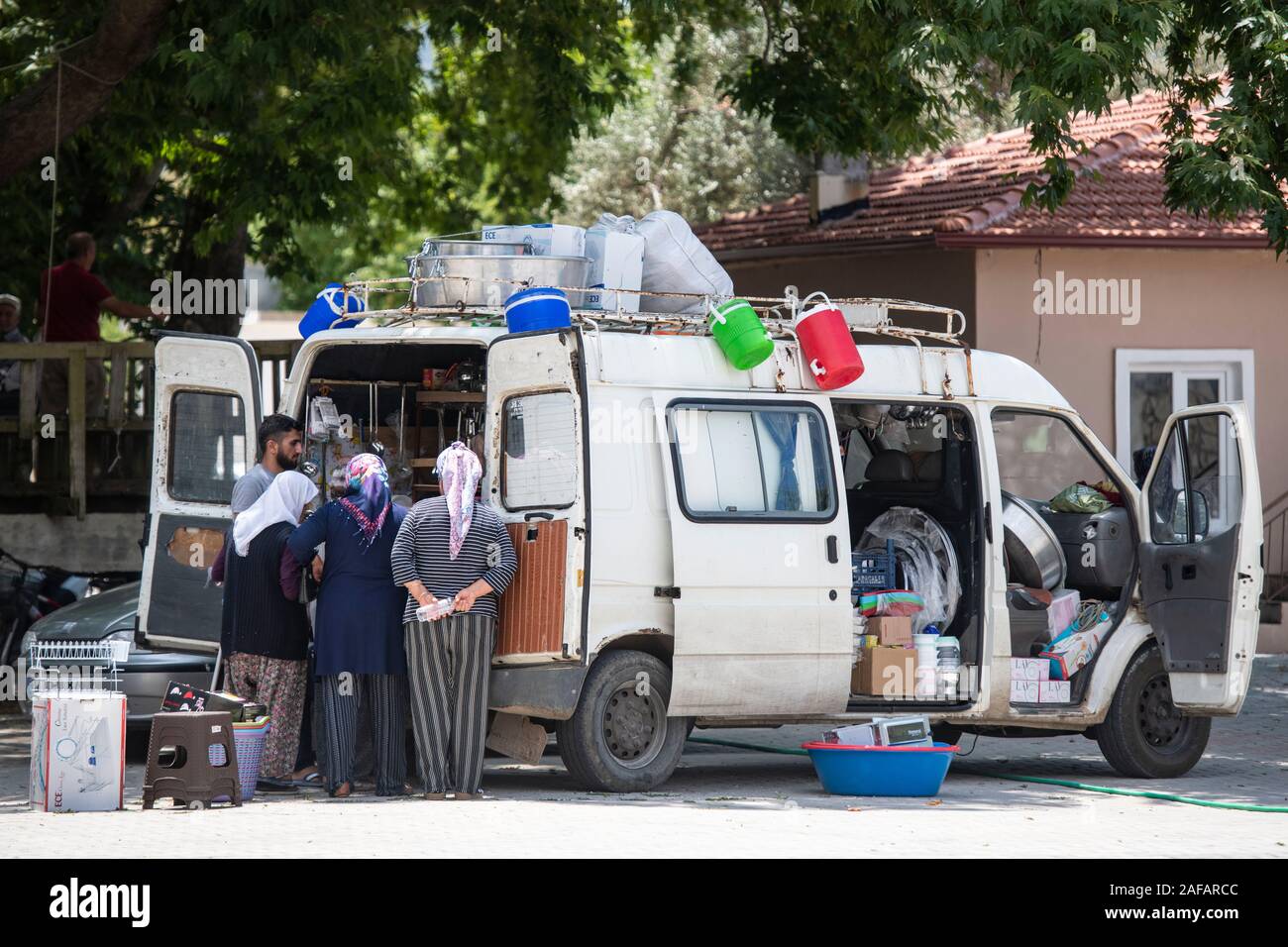 A travelling salesman sell his wares in the square of a remote Turkish ...