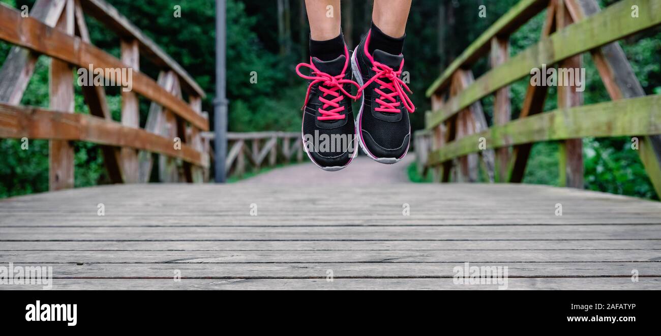Athlete woman feet jumping outdoors Stock Photo - Alamy