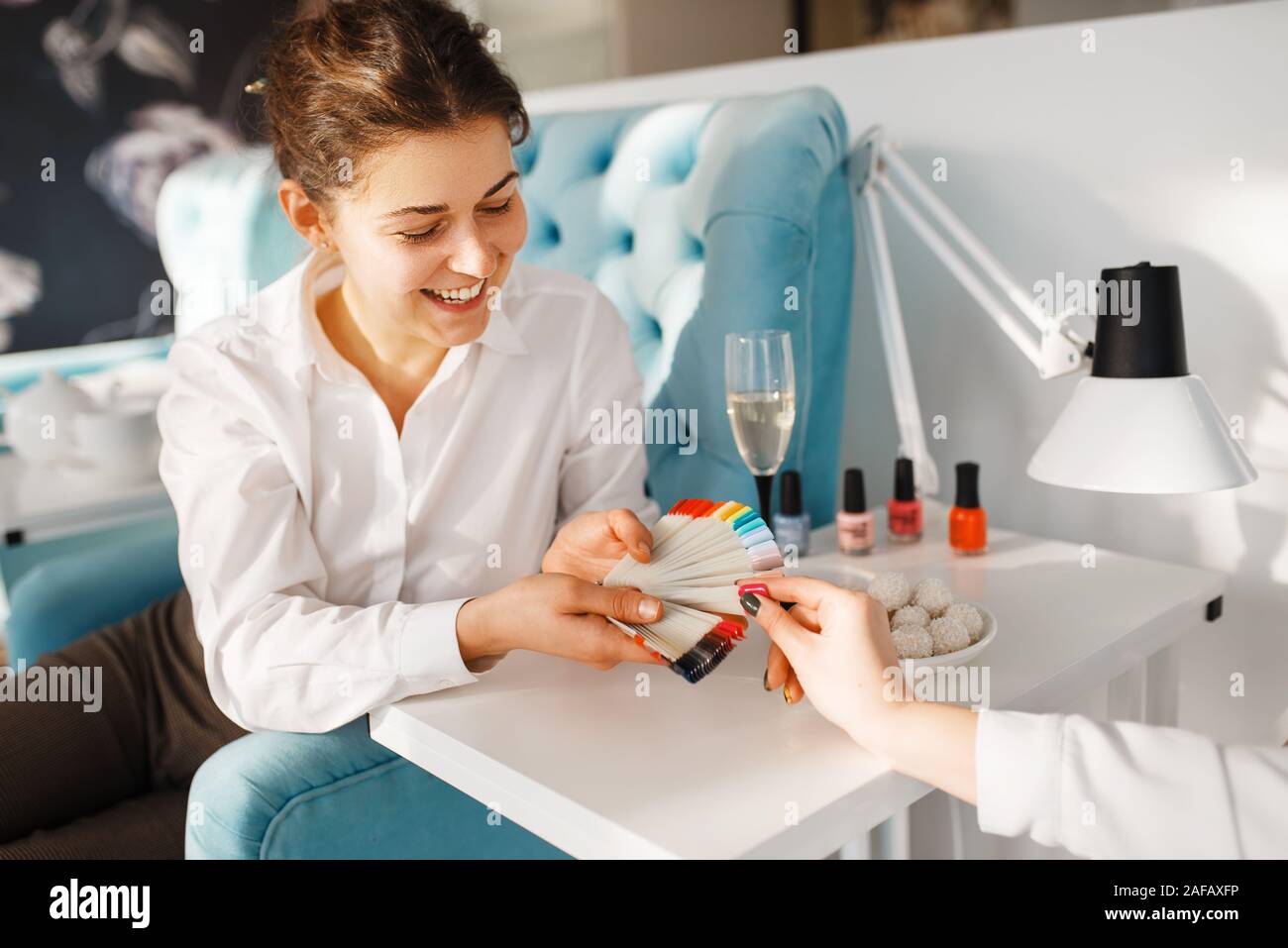 Woman with color palette choosing nail varnish Stock Photo - Alamy