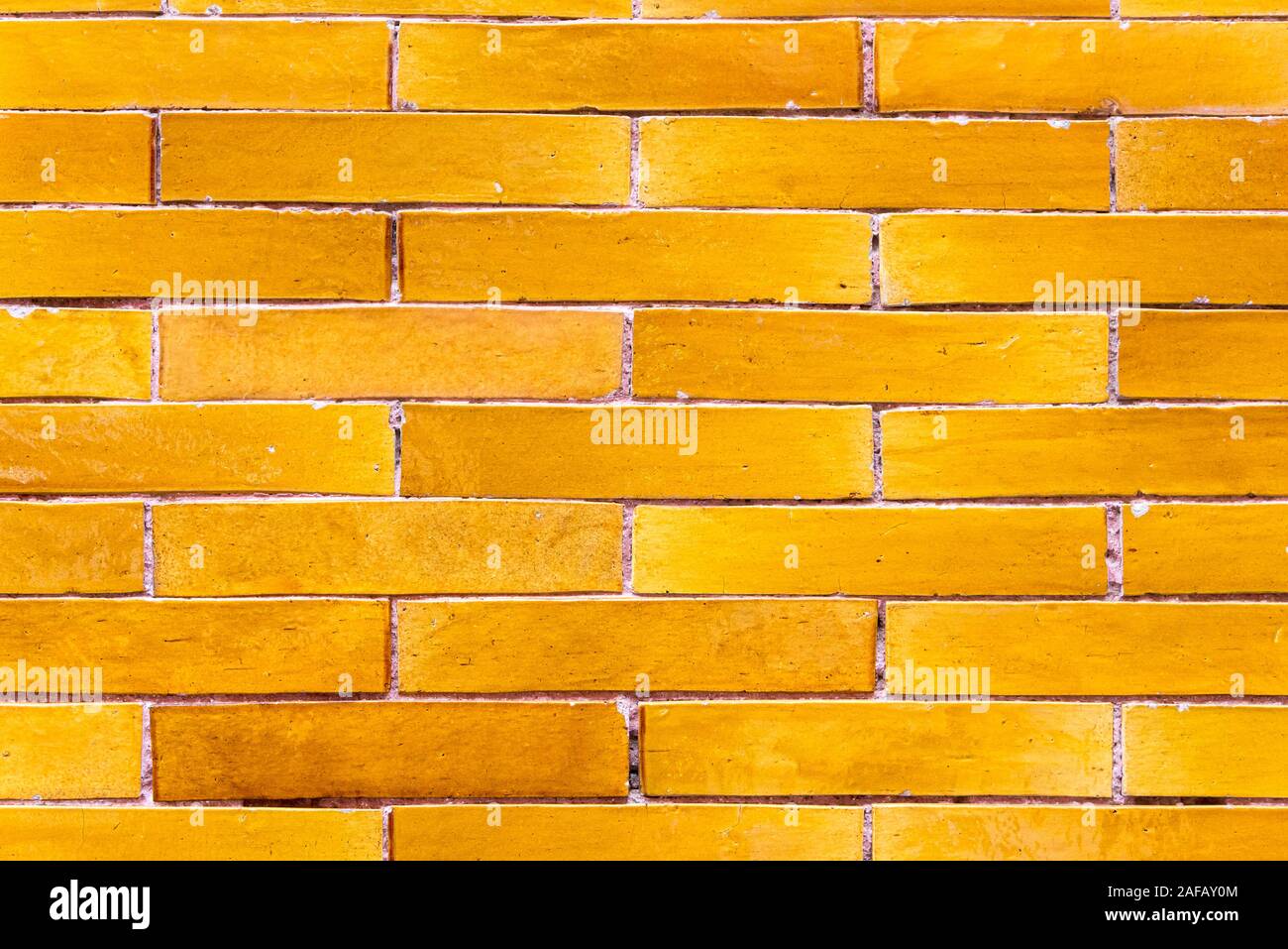 Detail of yellow brick wall Stock Photo - Alamy