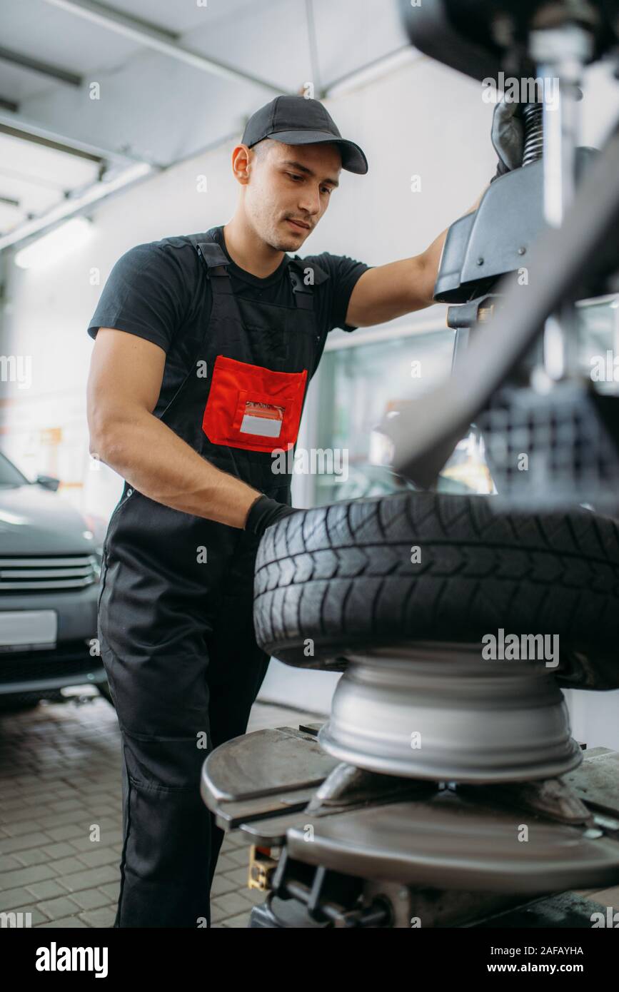 Mechanic change tire, repairing service Stock Photo - Alamy