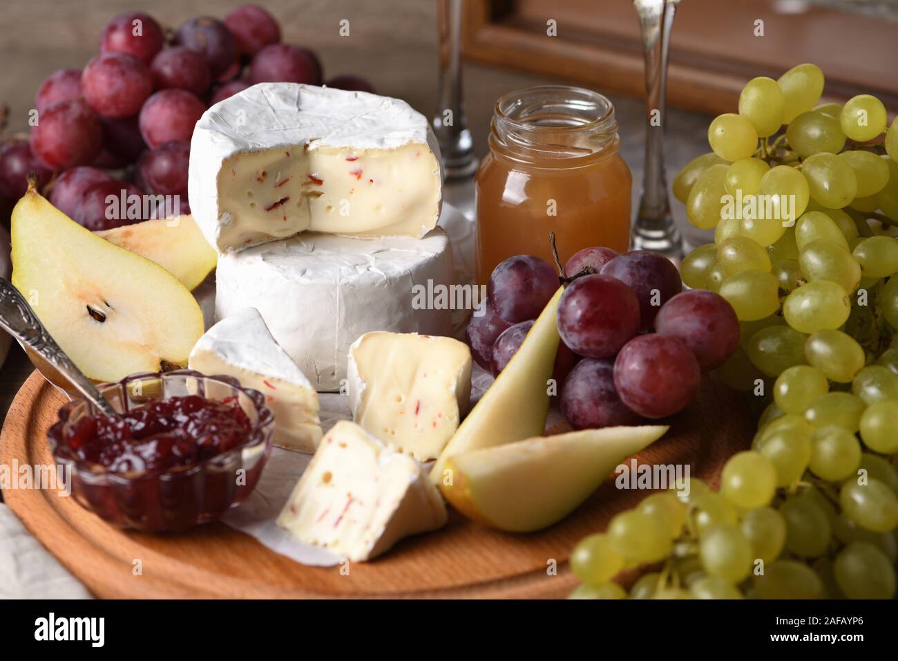 Antipasti. Cheese camembert with grapes, sliced pears and confiture, a ...