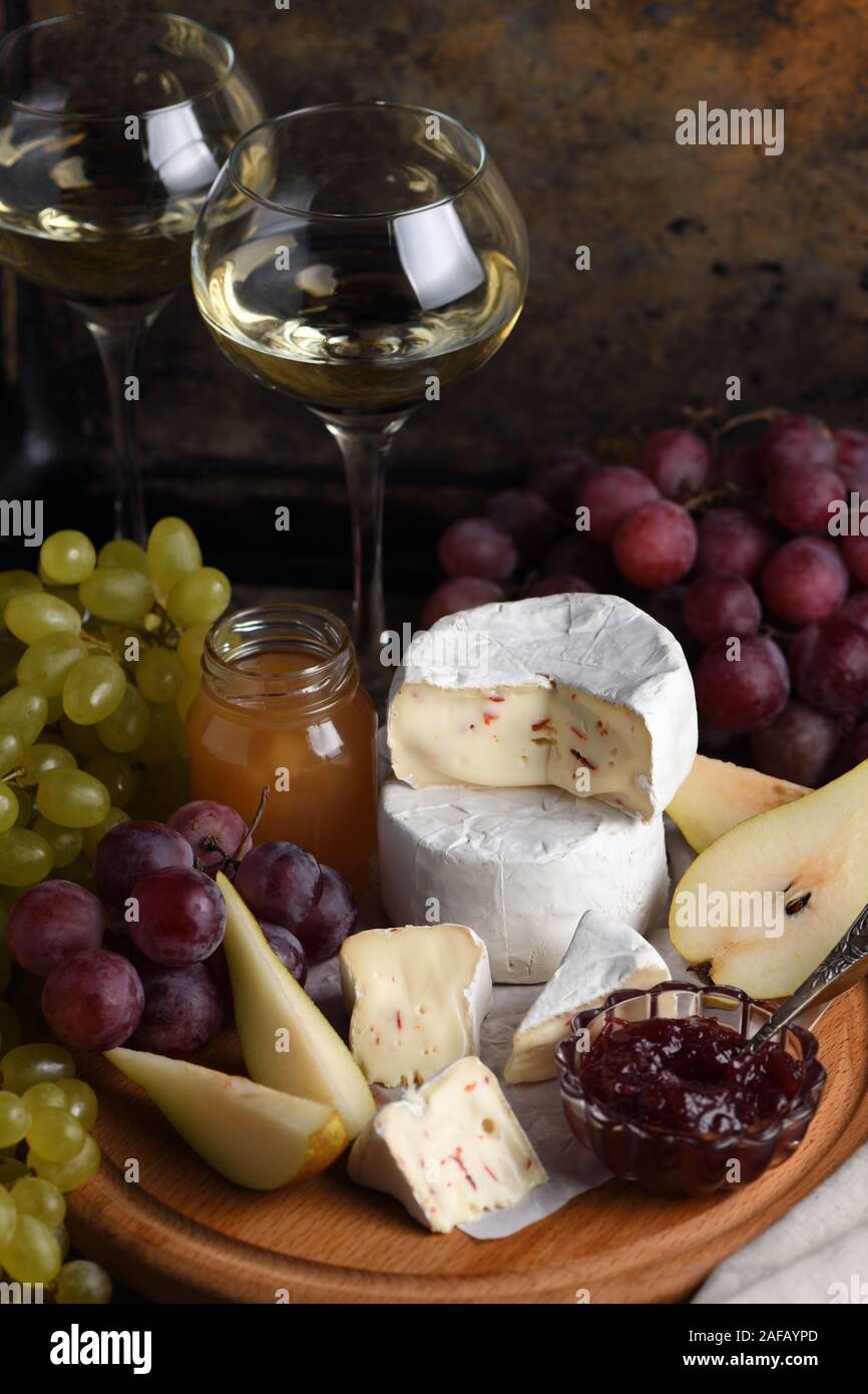 Antipasti. Cheese camembert with grapes, sliced pears and confiture, a ...
