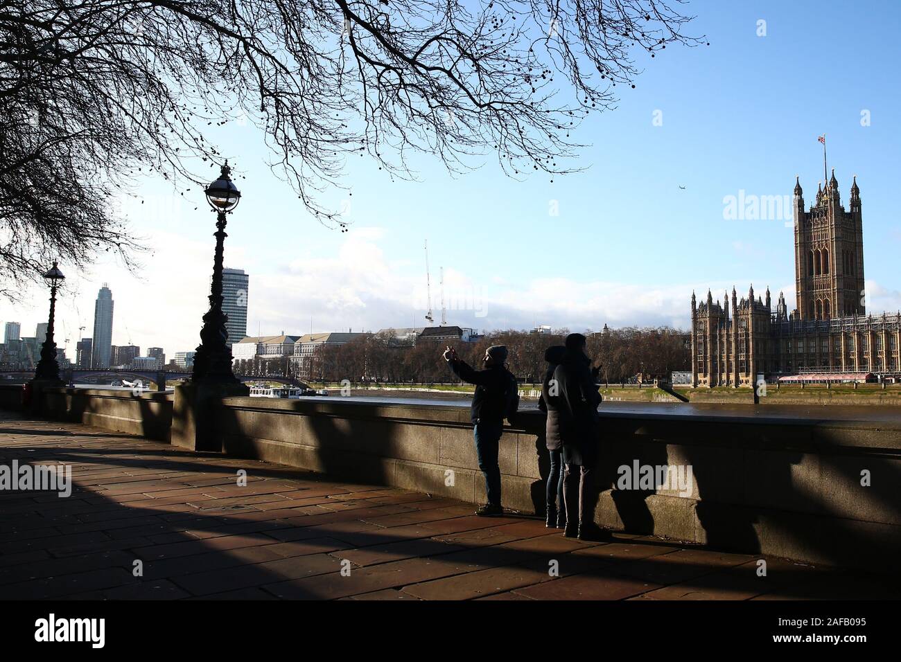 A person taking a selfie with the Houses of Parliament in London behind ...