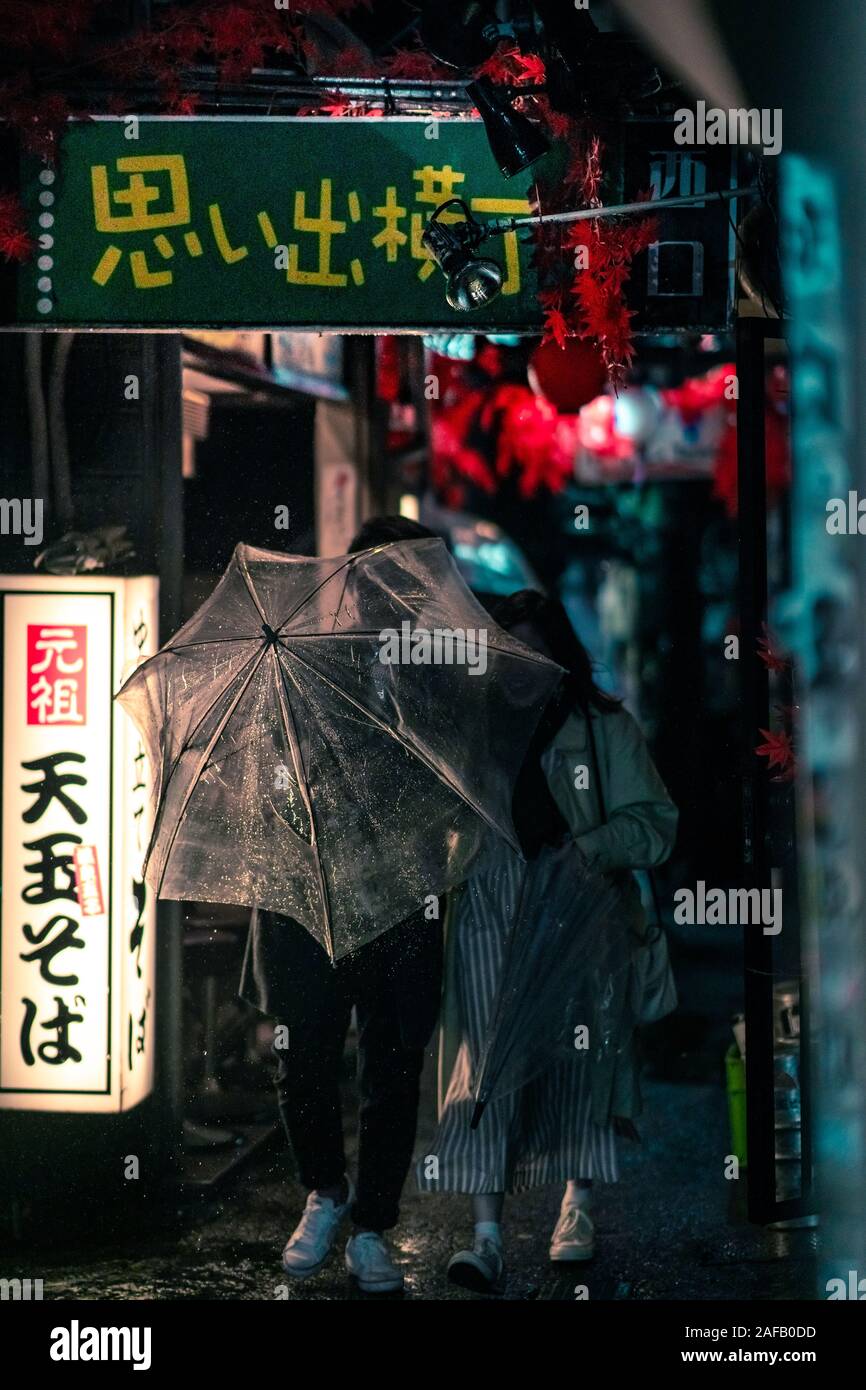 man walking out of restaurant getting ready to walk in a rainy day ...