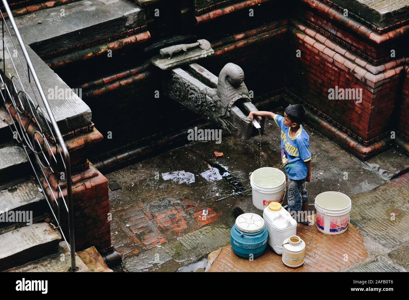 Kid looking for water in Kathmandu Stock Photo - Alamy