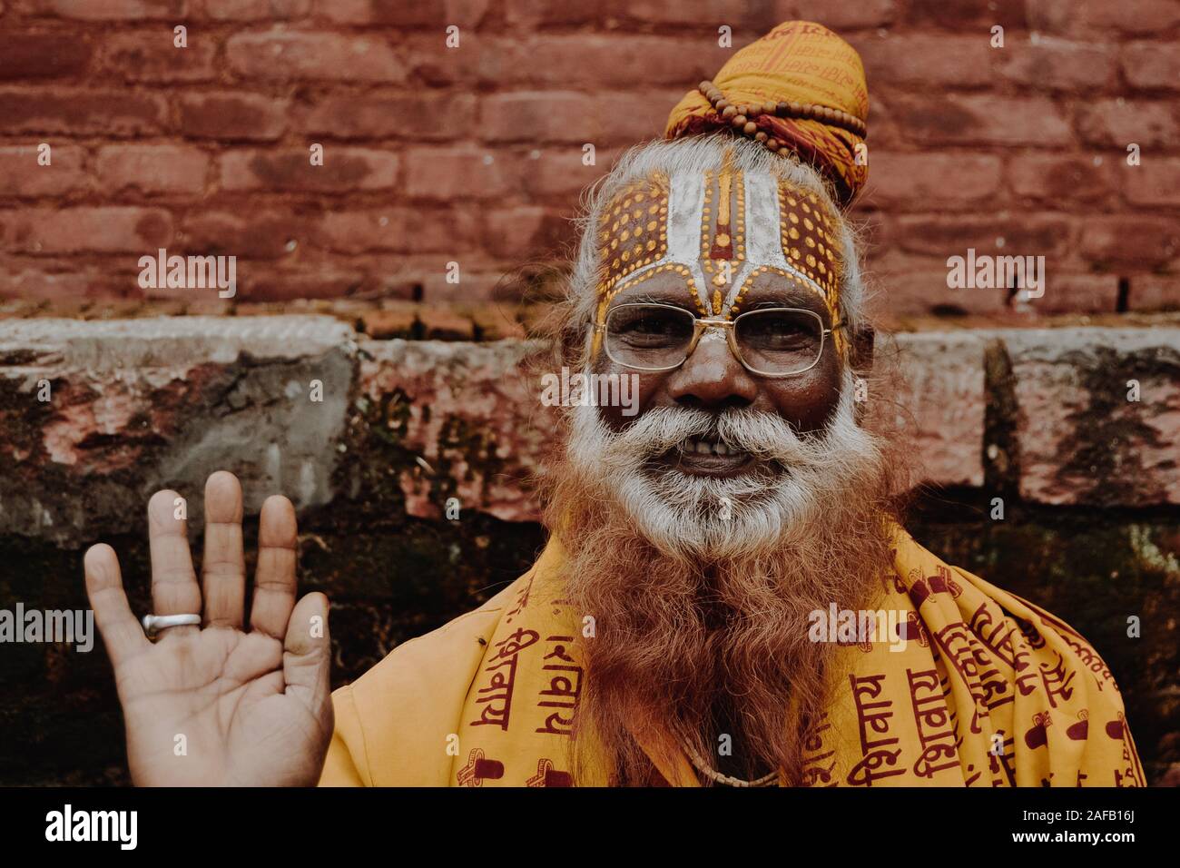 Nepali holy men dress in yellow and with the painted face Stock Photo ...