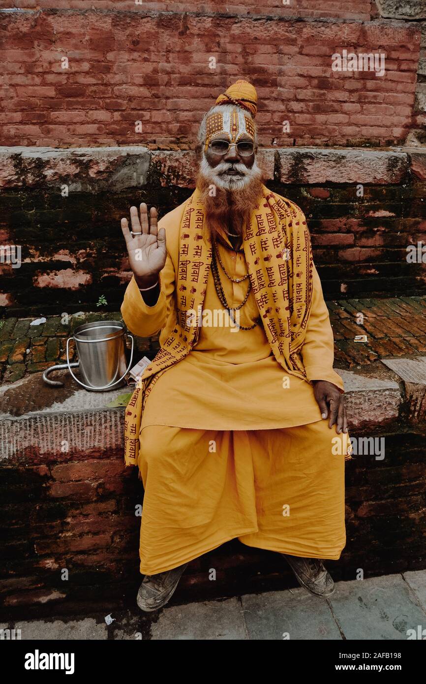Nepali holy men dress in yellow and with the painted face Stock Photo ...