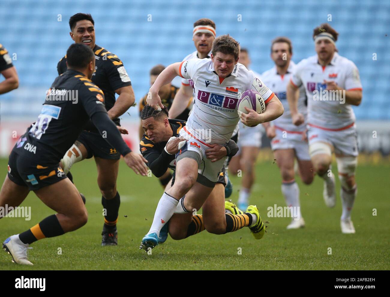 Wasps' Marcus Watson tackles Edinburgh Rugby's James Johnstone during ...