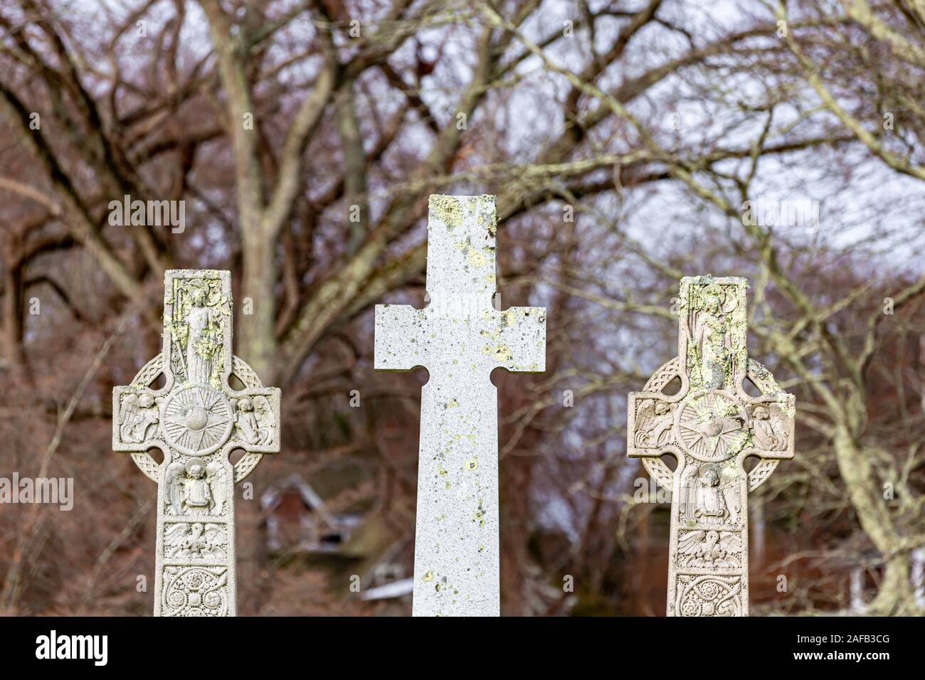 Three stone crosses, tow ornate and one plain in winter landscape Stock ...