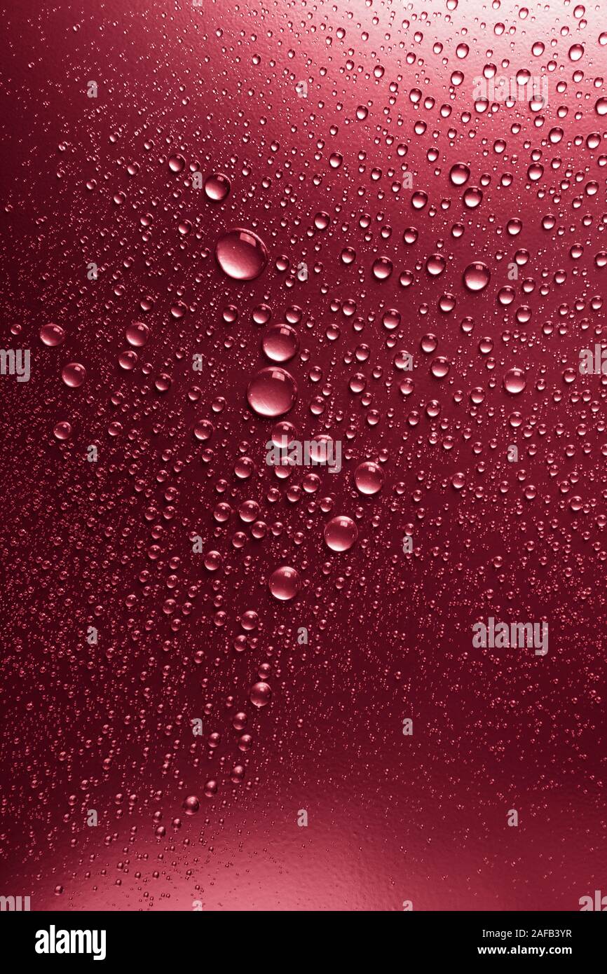 Bubbles of water on shaded surface, red background Stock Photo - Alamy