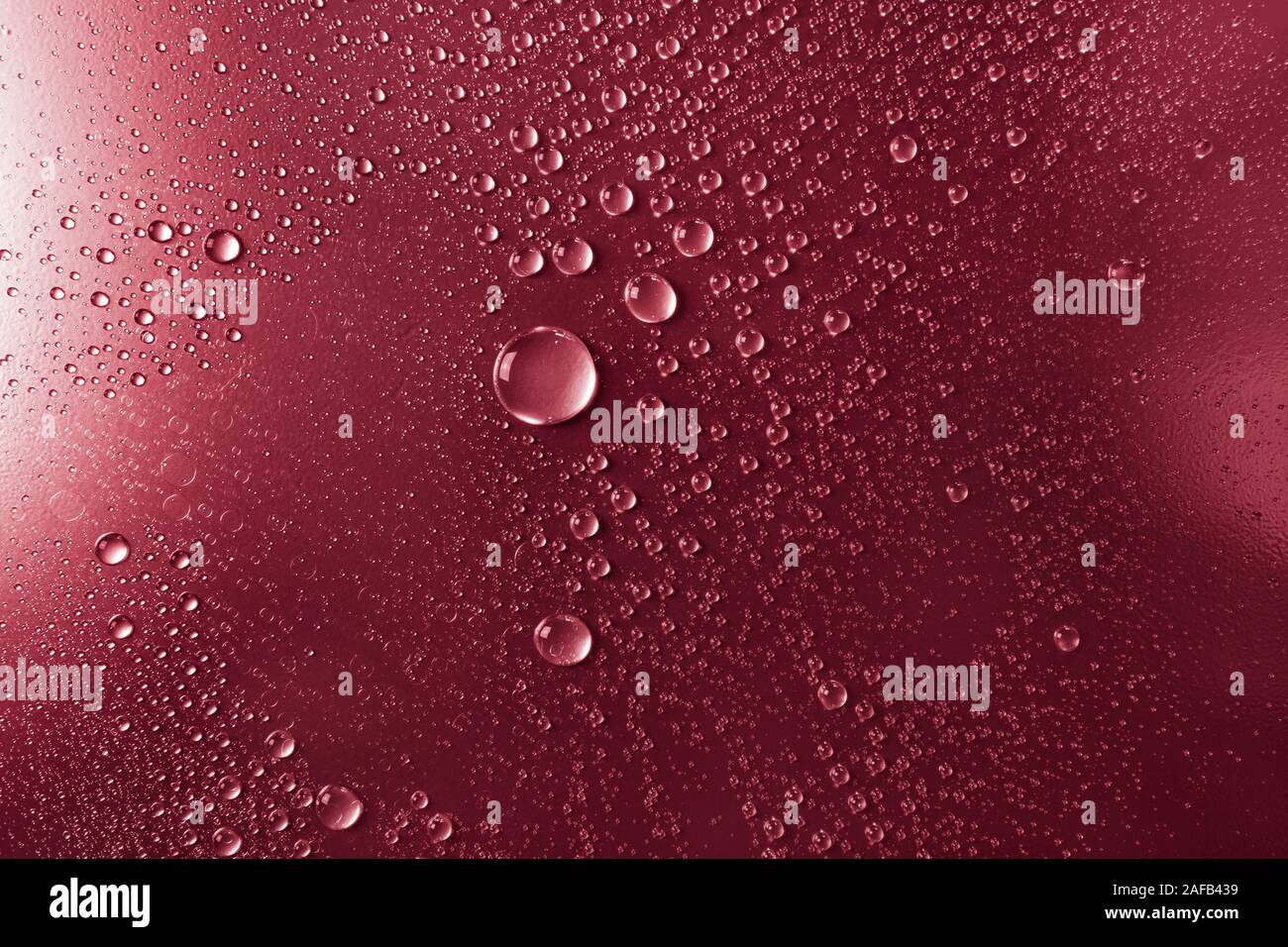 Bubbles of water on shaded surface, red background Stock Photo - Alamy
