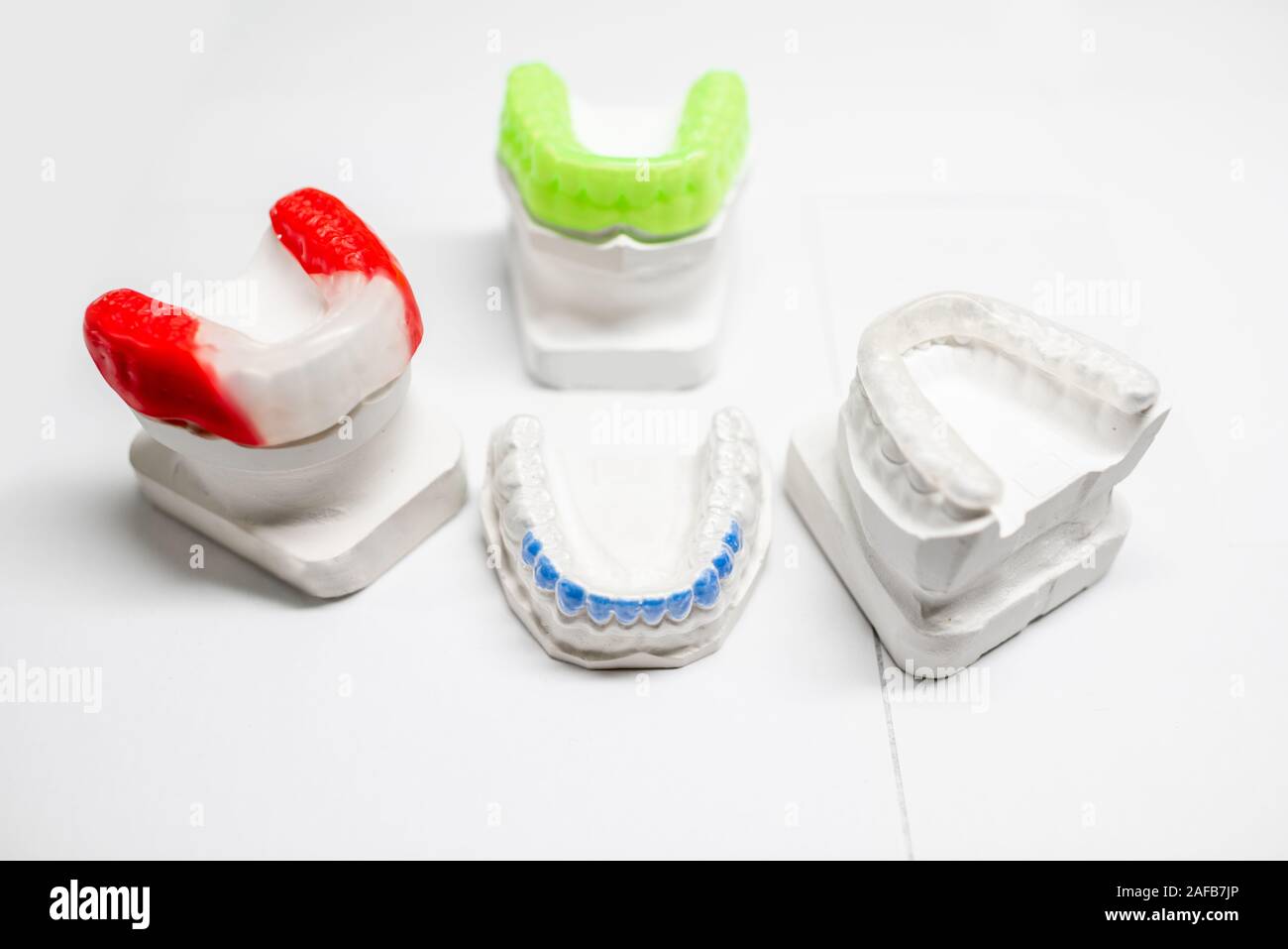 Gypsum models of artificial jaw with dental caps on the white ...